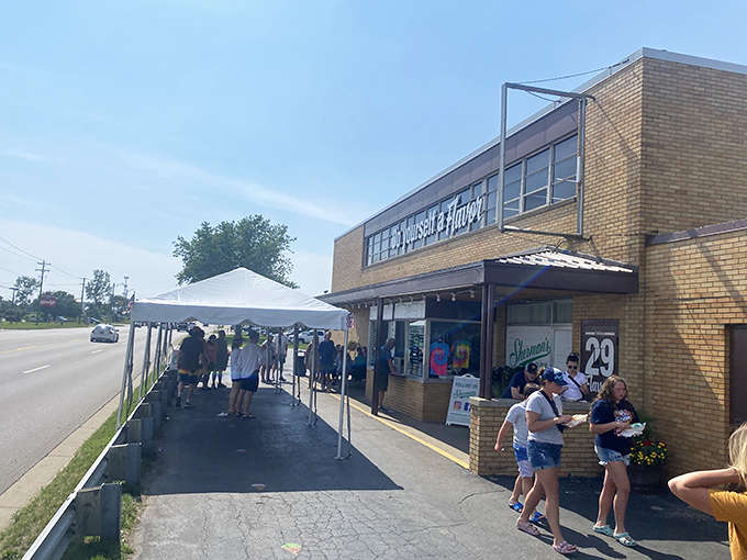 The iconic brick exterior of Sherman's Dairy Bar, where summer memories are scooped daily and lines of eager customers are just part of the tradition.