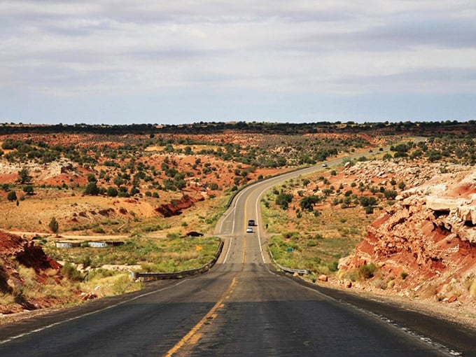The open road beckons with promises of adventure as State Route 98 stretches toward the horizon, cutting through Arizona's painted desert landscape.
