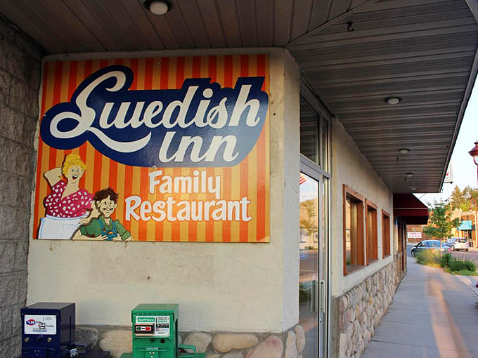 The iconic orange-striped sign of Swedish Inn beckons hungry travelers with its cheerful vintage charm and promise of homestyle cooking.