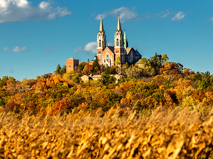 Holy Hill rises majestically above Wisconsin's autumn landscape, its twin spires piercing a perfect blue sky like something from a European fairytale.