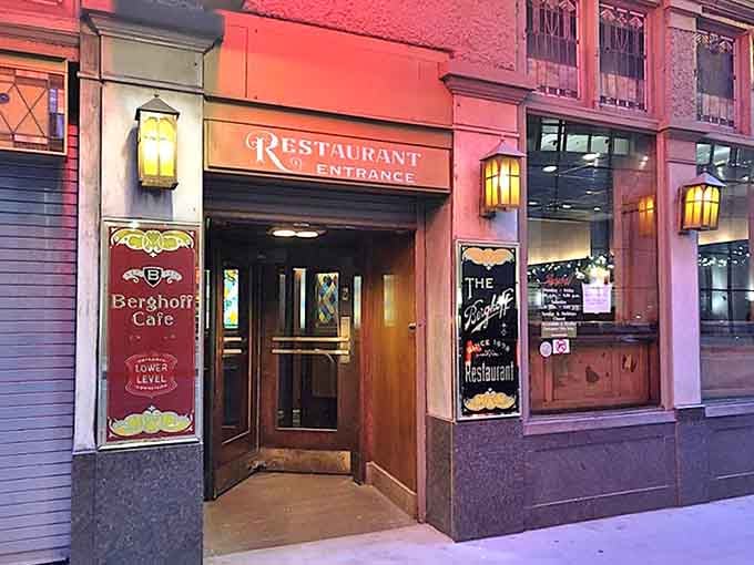 The iconic restaurant entrance beckons with warm amber lighting, promising old-world charm and modern delights just beyond those wooden doors.
