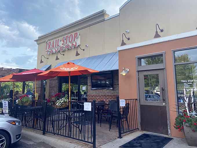 Trail Stop Tavern welcomes you with cheerful umbrellas and a patio that promises good times ahead, like a friend waving from across the street.
