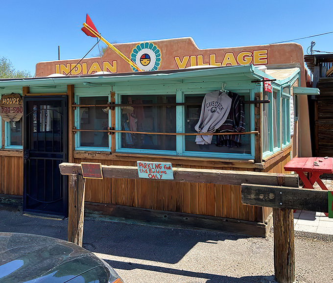 The iconic adobe facade of Indian Village stands proudly against the Arizona sky, promising culinary treasures within its humble walls.