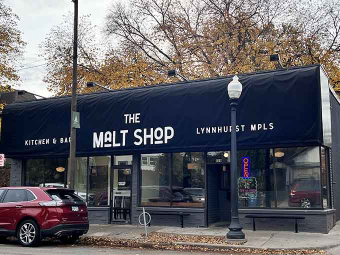 The sleek black exterior of The Malt Shop beckons like a well-kept secret on Lynnhurst, proving great burgers don't need flashy signs.