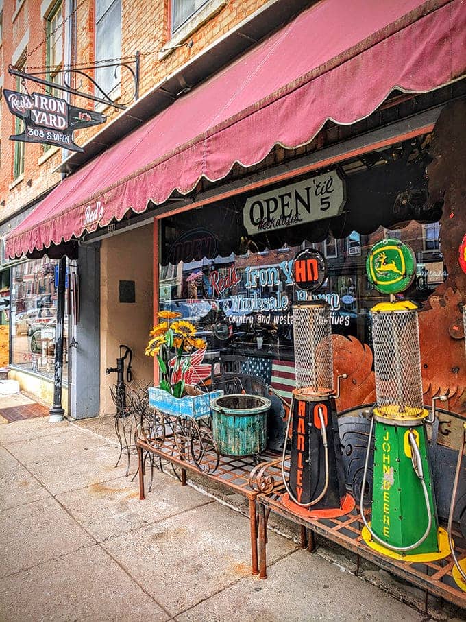 That pink awning welcomes treasure hunters like a beacon of hope for anyone who's ever wanted vintage gas pumps guarding their driveway.