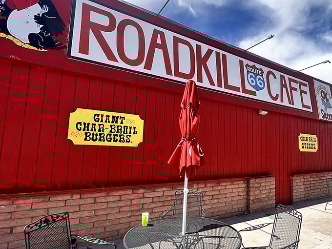 The iconic red exterior of Roadkill Cafe stands out against the Arizona sky, promising Route 66 travelers a memorable dining experience with its "Giant Char-Broil Burgers."