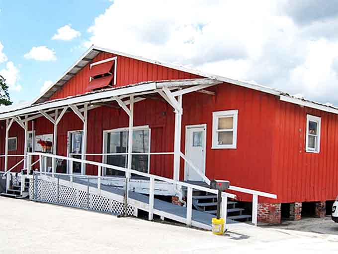A bright red barn-like structure that stands proudly against the Florida sky, beckoning treasure hunters with its rustic charm and welcoming ramp entrance.