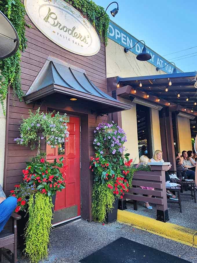 That charming red door flanked by cascading flowers is your gateway to pasta paradise in Minneapolis.