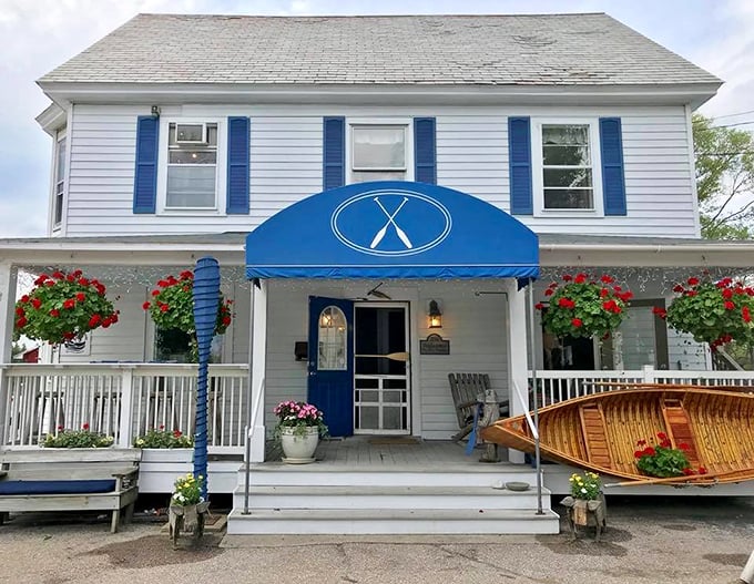 The charming exterior of Blue Paddle Bistro welcomes you with classic Vermont character &ndash; white clapboard, blue accents, and flowers that say "come on in!"