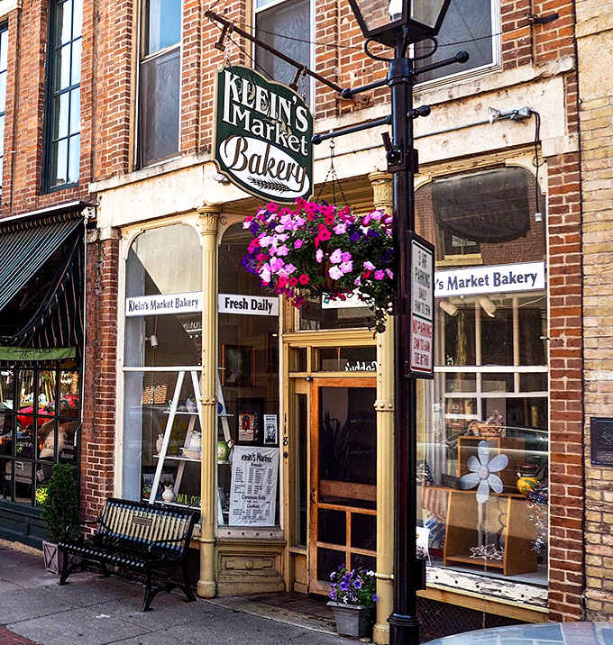 Klein's Market Bakery's charming brick storefront beckons with its vintage sign and hanging flower baskets &ndash; a sweet prelude to the treasures within.