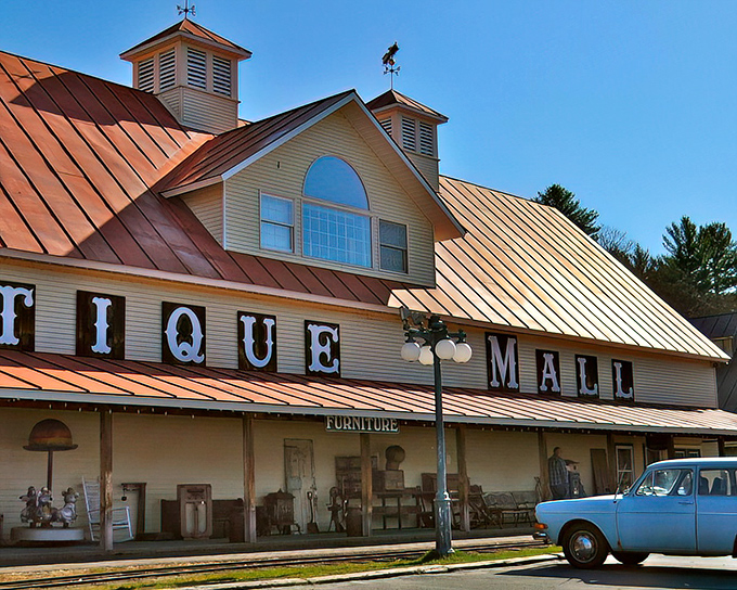 The iconic red-roofed Quechee Antique Mall stands proudly against the Vermont sky, beckoning treasure hunters with its vintage charm.