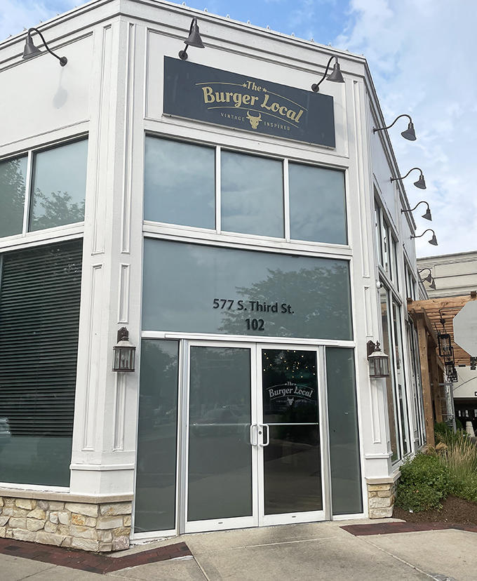 The unassuming exterior hides burger greatness within, like Clark Kent hiding Superman, but with more pretzel buns and less spandex.
