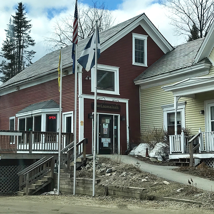 The charming red exterior of MacLaomainn's Scottish Pub welcomes visitors with authentic Highland promise in the heart of Chester, Vermont.