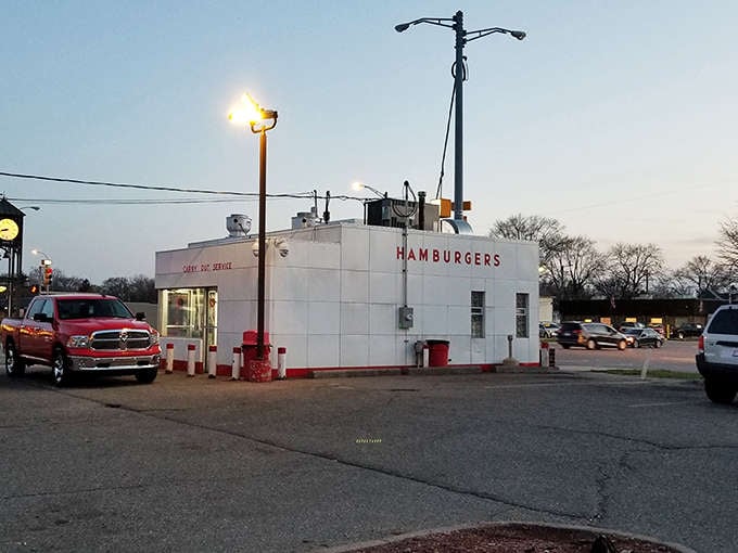 The iconic white exterior glows like a midnight lighthouse for hungry travelers, its "HAMBURGERS" sign a promise of simple pleasures inside.