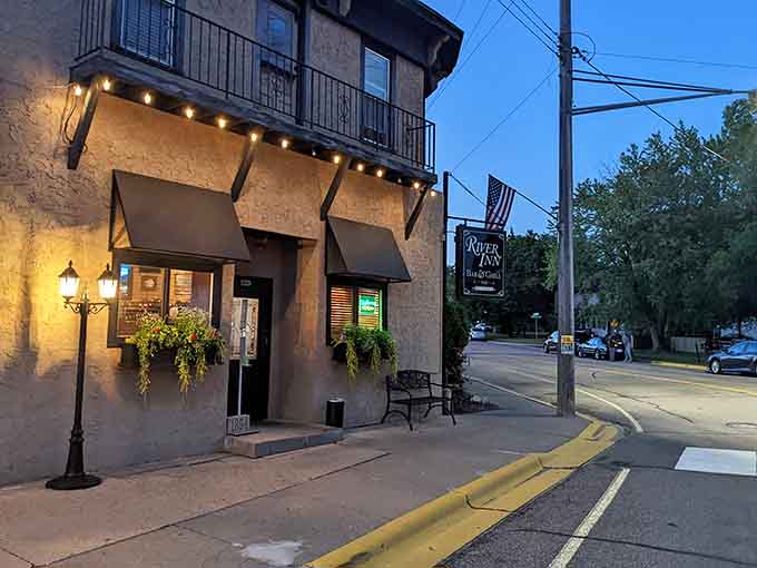 River Inn Bar & Grill beckons from its corner perch, where string lights promise good times and even better walleye inside.