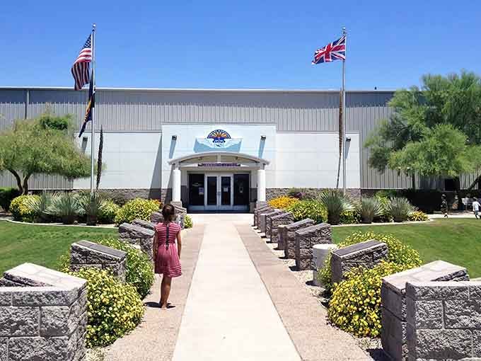 Two flags wave proudly over this aviation sanctuary where history takes flight daily, welcoming visitors to step back in time.