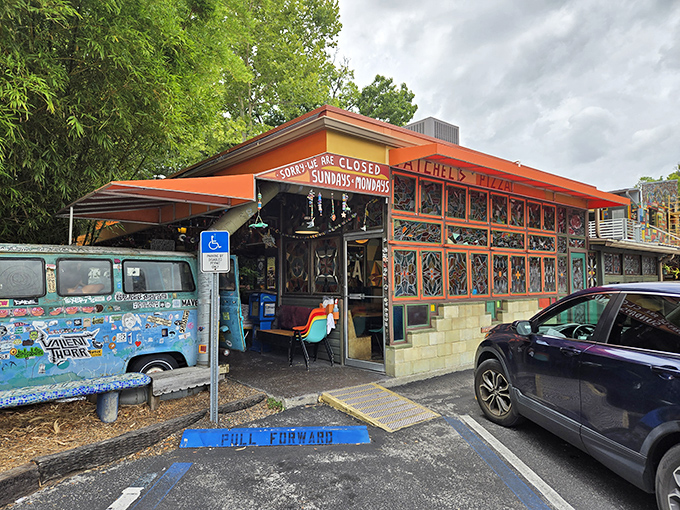 The vibrant orange exterior of Satchel's Pizza, with its iconic sticker-covered VW bus, promises an adventure before you even step inside.