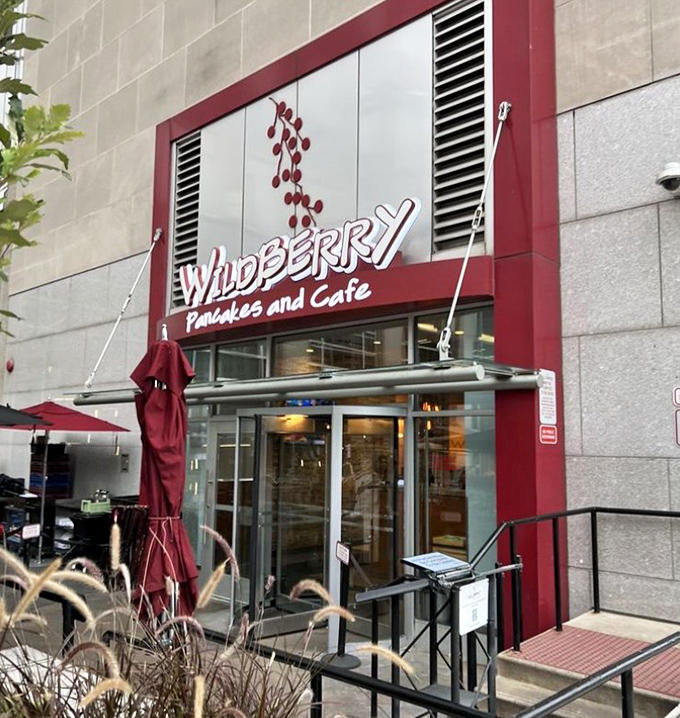 That cheerful red awning beckons like a breakfast beacon, promising the kind of morning meal that makes you glad you got out of bed.