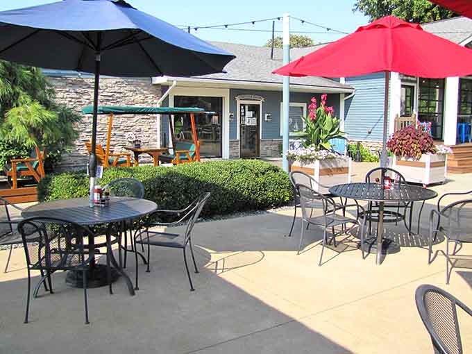 The outdoor patio at Crow's Nest beckons like a lakeside oasis where umbrellas and good times multiply.