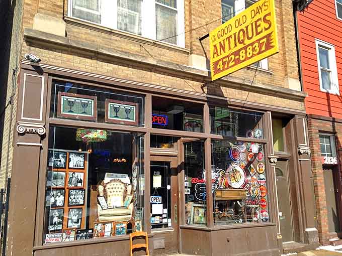 The bright yellow "GOOD OLD DAYS ANTIQUES" sign beckons passersby into a brick time capsule on Belmont Avenue.