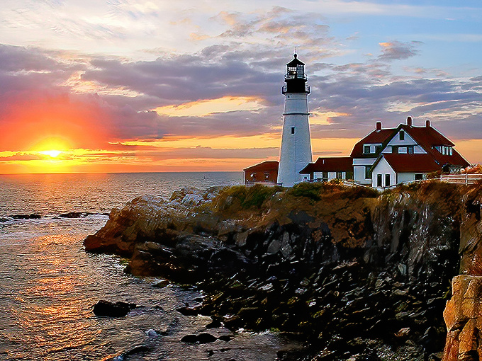 Portland Head Light stands majestically against a fiery sunset, nature's own light show competing with this historic beacon's steady glow.