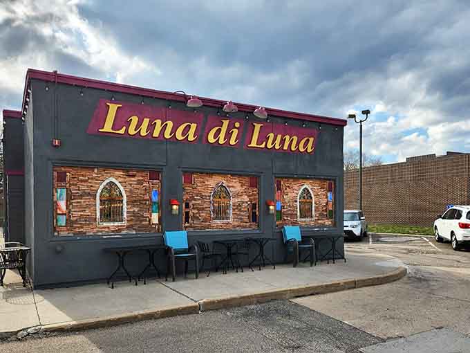 That charming exterior with its arched windows and glowing sign promises Italian magic, and spoiler alert: it absolutely delivers on that promise.