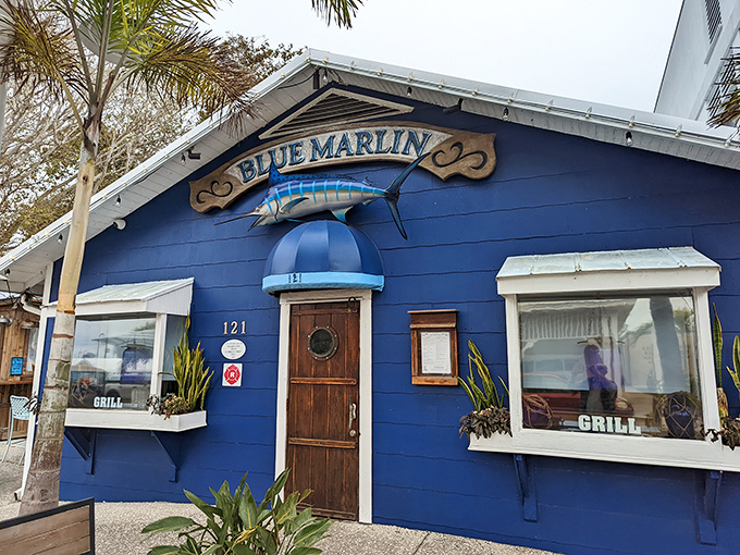 The vibrant blue exterior of Blue Marlin stands out like a sapphire against Florida's palms, promising seafood treasures within its humble walls.