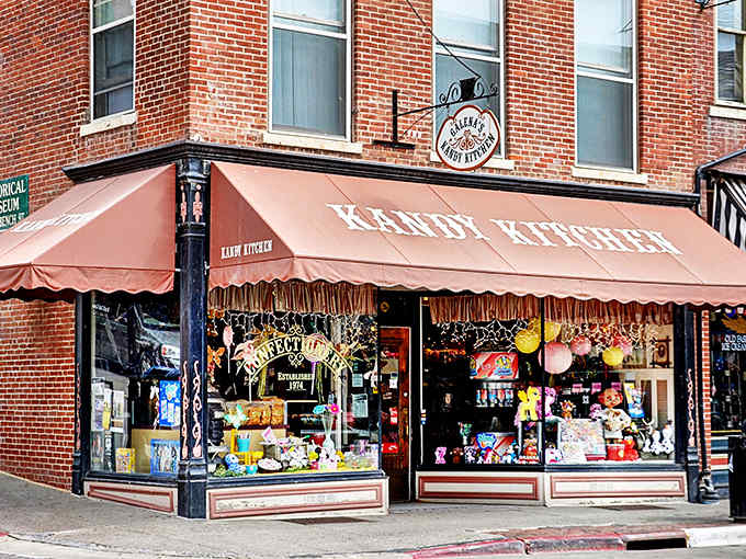 That coral awning beckons like a lighthouse for the sugar-obsessed, promising refuge from a world with insufficient chocolate.