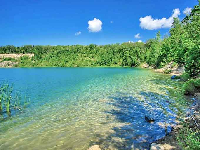 Nature's perfect swimming pool: Tioga Mine Pit's turquoise waters make you question whether you're still in Minnesota or teleported to the Caribbean.