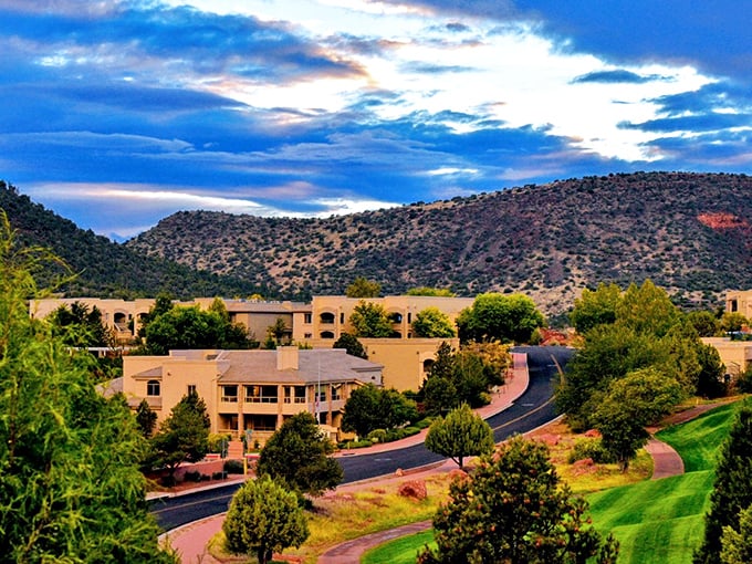 Village of Oak Creek sprawls beneath dramatic red cliffs, where adobe-style homes blend with the landscape like they've always belonged there.