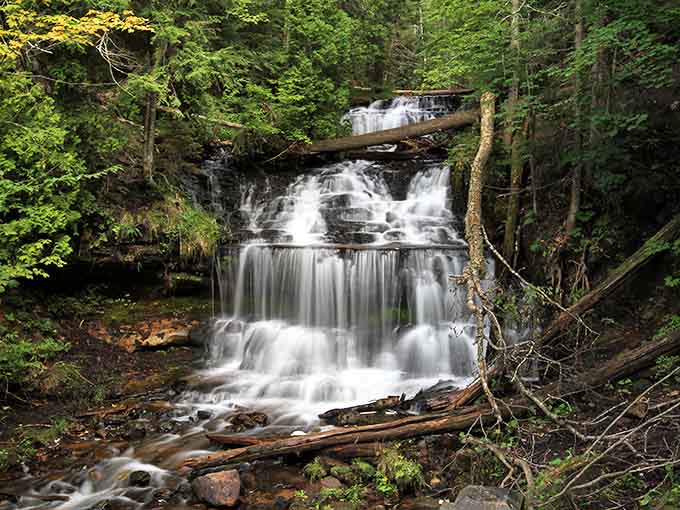 Wagner Falls cascades gracefully through Michigan's forest, creating nature's perfect soundtrack for forest bathing enthusiasts and photographers alike.