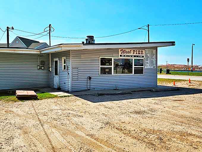 The unassuming exterior of West Pier Drive-In belies the culinary treasures within, a humble shrine to burger perfection nestled near Michigan's International Bridge.
