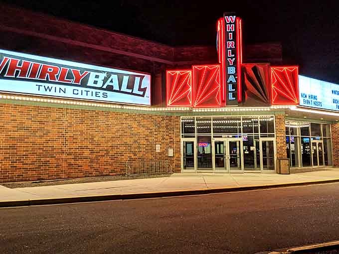 The iconic WhirlyBall Twin Cities sign glows like a beacon of fun against the night sky, promising adventures that your inner child has been desperately craving.
