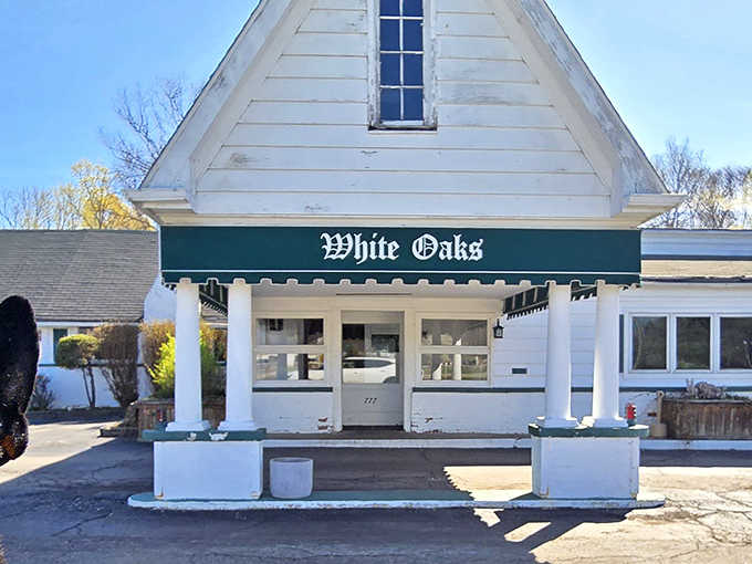The charming exterior of White Oaks Restaurant beckons with its classic white clapboard and distinctive green awning &ndash; an architectural appetizer for the culinary delights within.