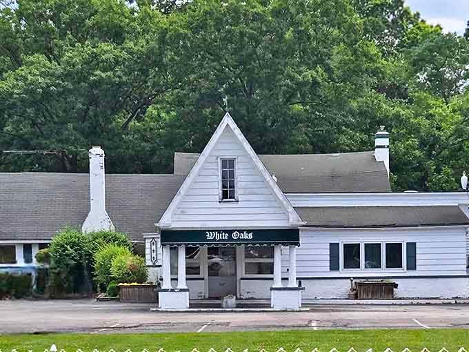 A charming white cottage with a green awning beckons like an old friend, hiding culinary treasures behind its modest facade.
