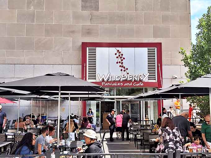 Wildberry's iconic red-framed entrance beckons breakfast enthusiasts with its promise of berry-infused delights and outdoor seating perfect for people-watching.