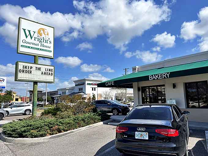 Wright's Gourmet House welcomes hungry visitors with its iconic green signage against Tampa's brilliant blue sky, promising culinary treasures within.