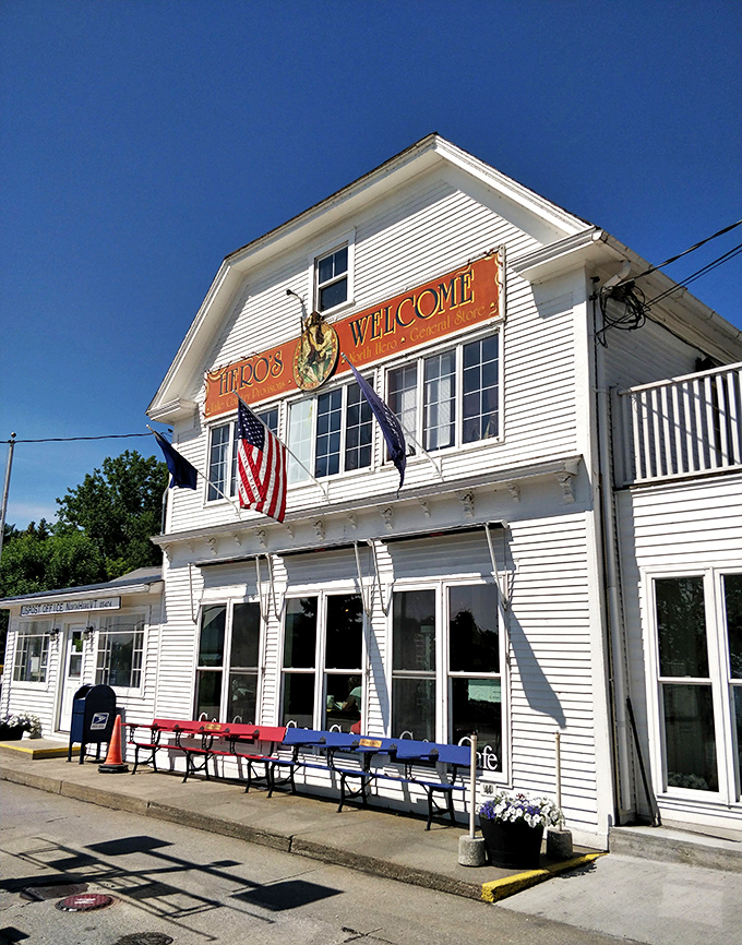 Classic Vermont charm greets visitors at Hero's Welcome, where the white clapboard exterior and welcoming sign promise authentic island hospitality.