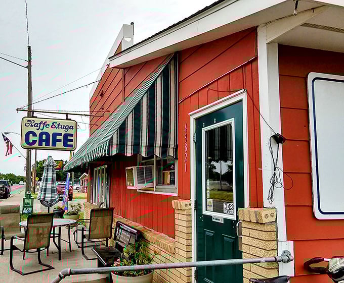 The bright red exterior with green-striped awnings stands like a culinary lighthouse on Highway 61, promising comfort food salvation to weary travelers.