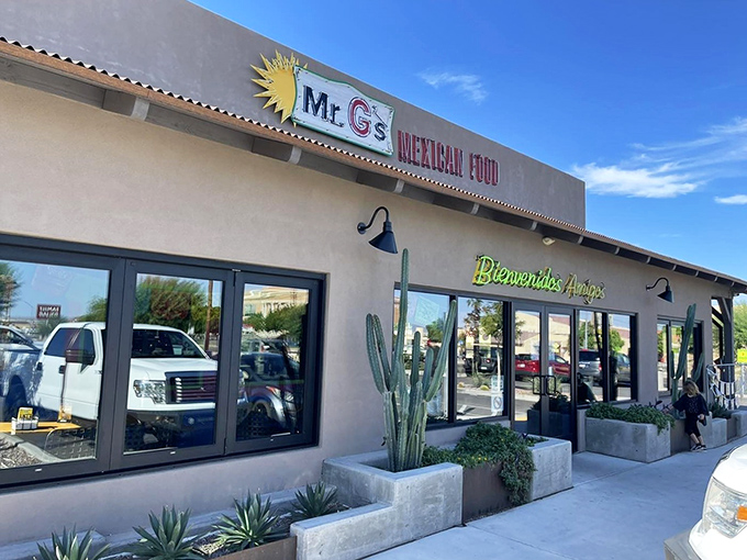 The sun-drenched exterior of Mr. G's welcomes hungry visitors with its cheerful "Bienvenidos Amigos" sign and desert landscaping &ndash; Yuma's colorful culinary beacon.