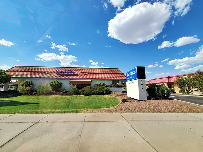 Fast Eddie's welcomes you with its iconic red-tiled roof and blue signage &ndash; a beacon of comfort food in the Arizona desert.
