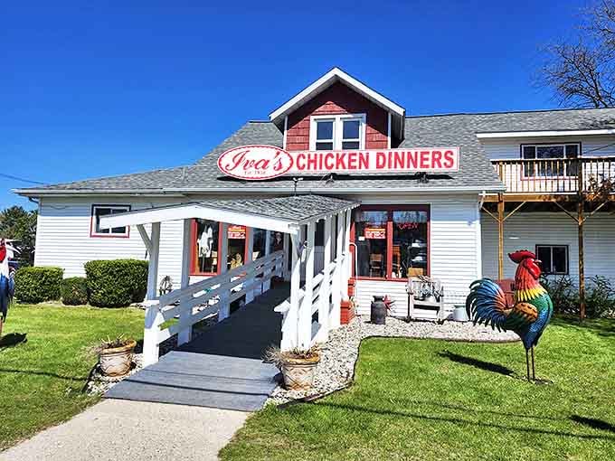 The charming exterior of Iva's beckons with its red-roofed welcome, like a storybook cottage that happens to serve legendary chicken.