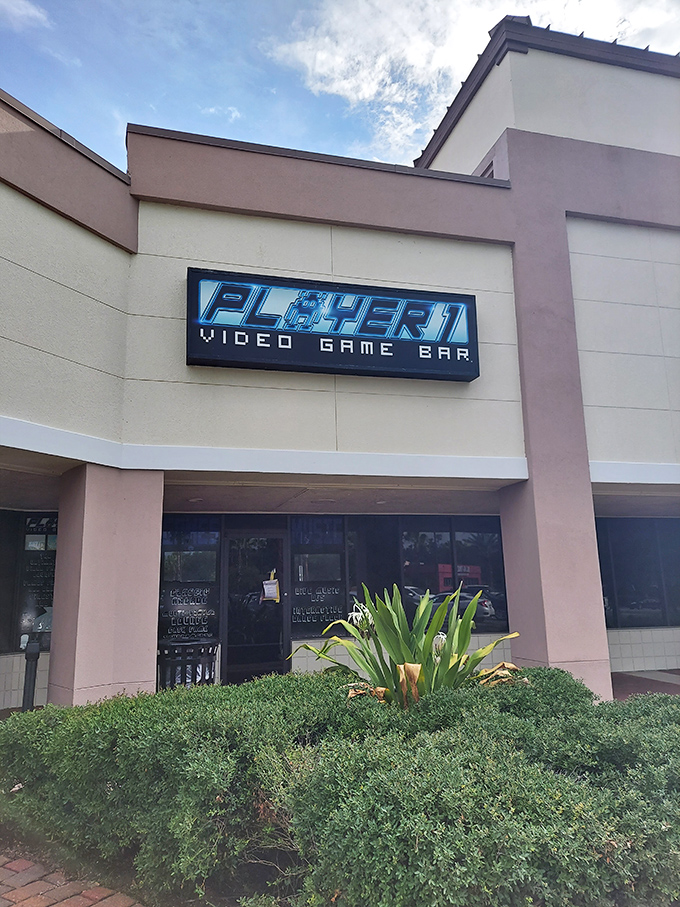 The glowing blue Player 1 sign stands out against the neutral building facade, like a beacon calling all gamers home to their digital playground.