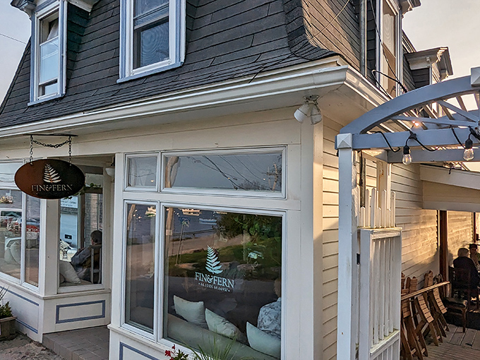 Fin and Fern's charming exterior welcomes seafood lovers with its coastal yellow clapboard and inviting entrance &ndash; Maine's culinary treasure chest awaits!