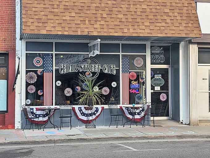 The patriotic bunting and cheerful window decorations announce this cafe's presence like a friendly wave from across the street.