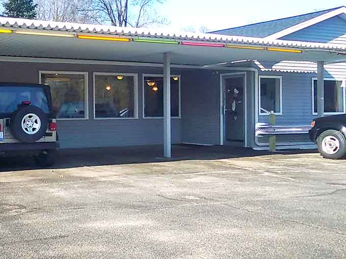 That vintage awning and those twinkling lights signal you've arrived somewhere special, where parking lots still mean something and good food awaits inside.
