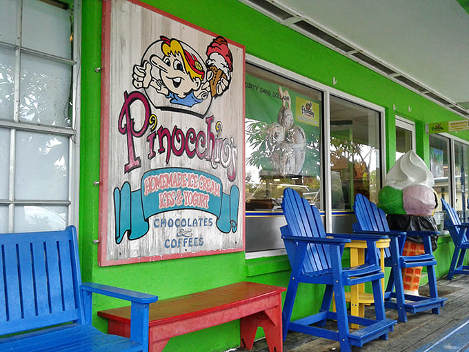 The vibrant lime-green exterior of Pinocchio's welcomes visitors with cheerful blue Adirondack chairs, promising sweet escapes and childhood nostalgia.