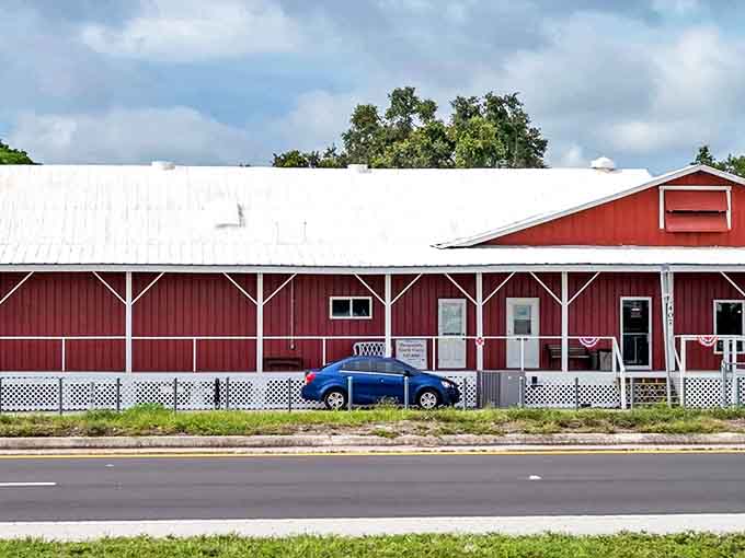 The Feed Store's classic red barn exterior stands like a beacon for treasure hunters, promising wonders within its weathered walls.