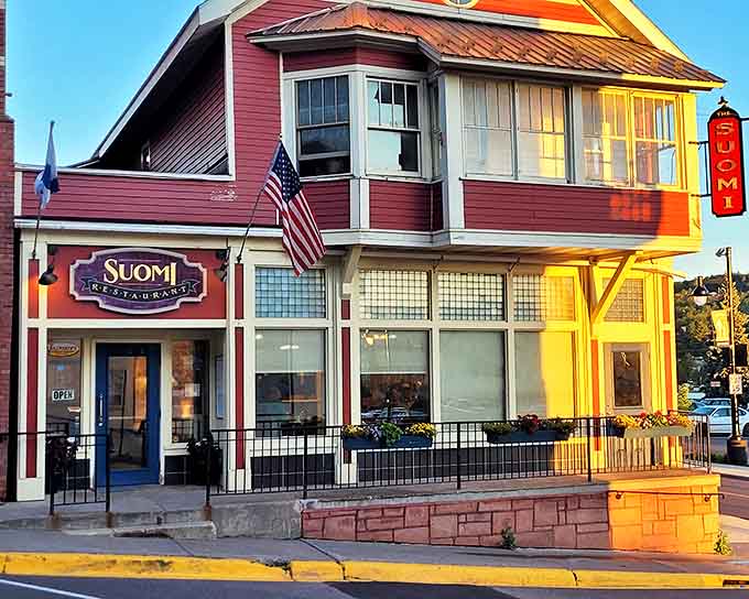 The charming red exterior of Suomi Restaurant glows in the late afternoon sun, promising Finnish comfort food that warms the soul.