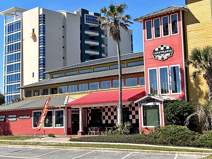 The Candymaker's vibrant red exterior stands out like a sweet beacon against Destin's skyline, promising sugary treasures within those checkered walls.